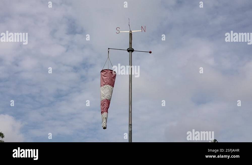 White and red windsock isolated on blue sky background. Check the wind ...