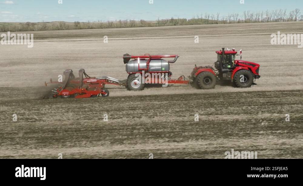 Tractor sowing seeds with seeder driller in field. Process of sowing ...
