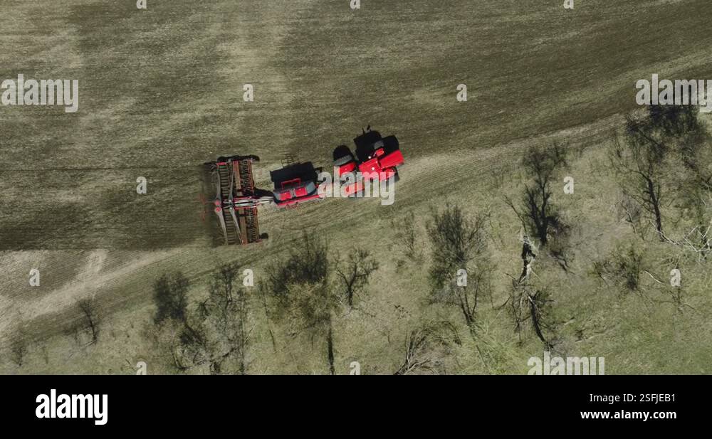 Tractor sowing seeds with seeder driller in field. Process of sowing ...