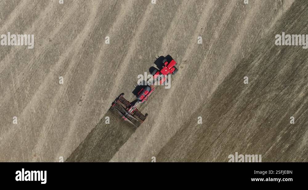 Tractor sowing seeds with seeder driller in field. Process of sowing ...