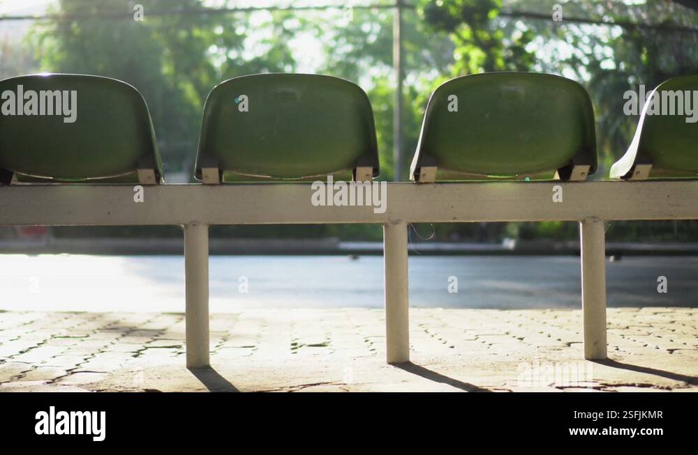 Cinematic urban scene of Bangkok Thailand bus stop seating in light sun ...