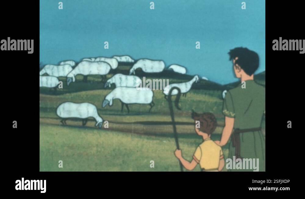 1960s: Shepherd and young boy stand watch over flock of sheep. Shepherd ...