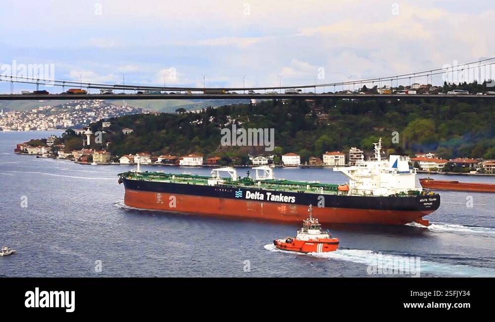 Super tanker ship sailing with a pilotage service boat in Straits ...