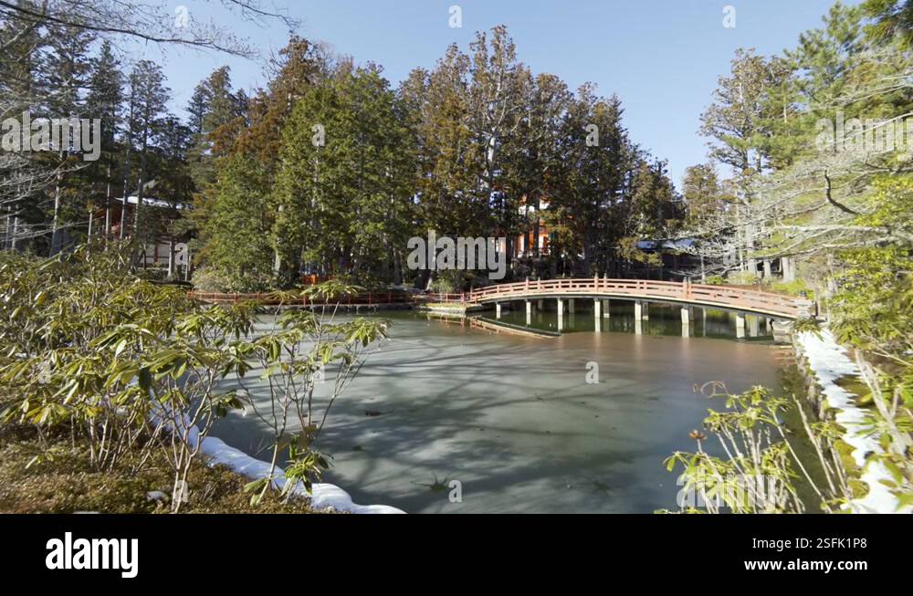 Cinematic gimbal shot of bridge and pond at Buddhist temple in Mount ...