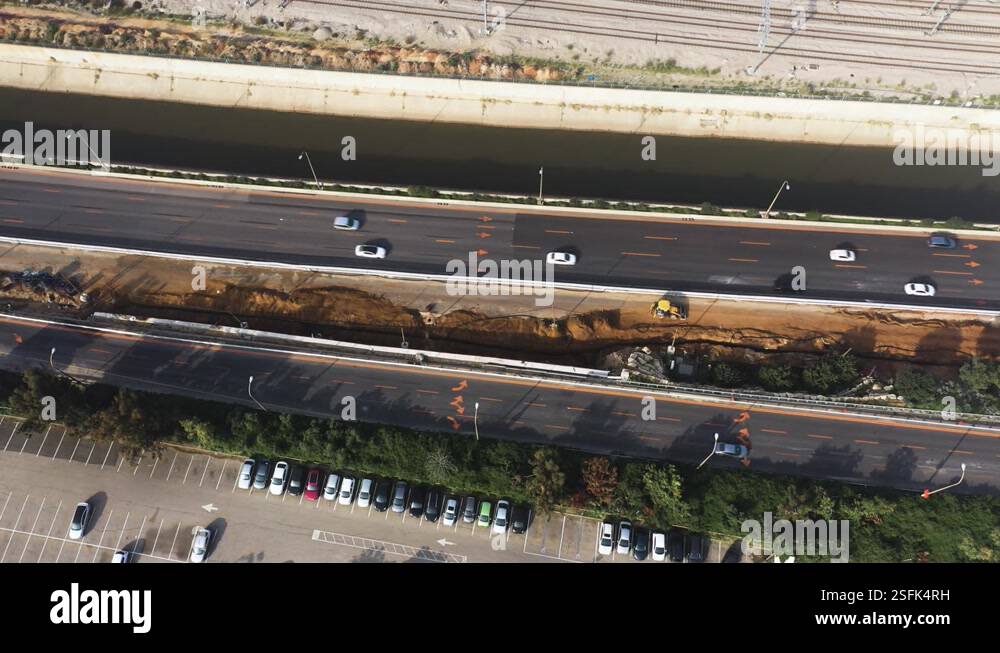 Freeway or main road with cars and parking lot from top down aerial ...