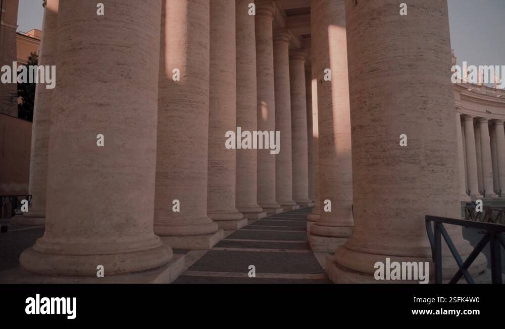 Beautiful white columns lit by a rising sun form a portico at St Peter ...