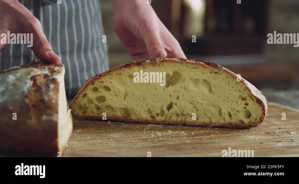 Macro of artisan baker chef controls quality of fresh bread taken out of oven Stock Video ...