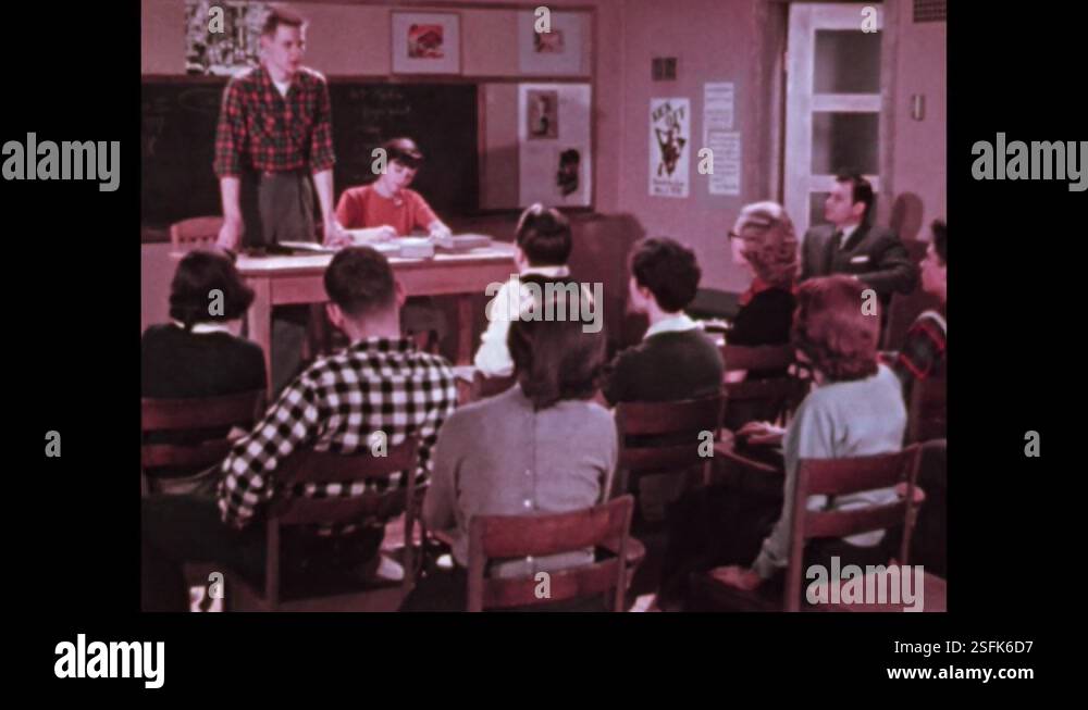 1950s: boy stands and speaks to class, students laugh at presentation ...