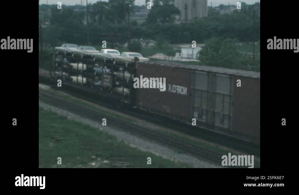 1960s: new cars on freight train, shipment of cars on train, overhead ...