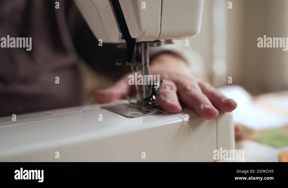 The process of starting sewing on an industrial sewing machine close-up ...