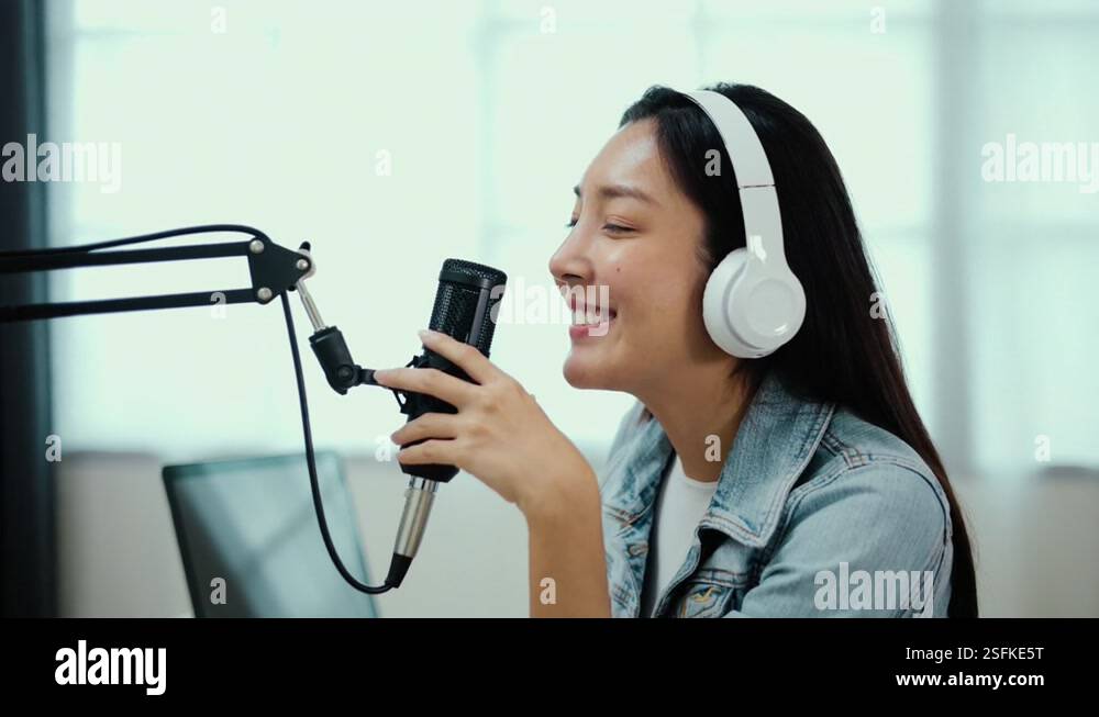 Content creator woman host streaming his a podcast on laptop with ...