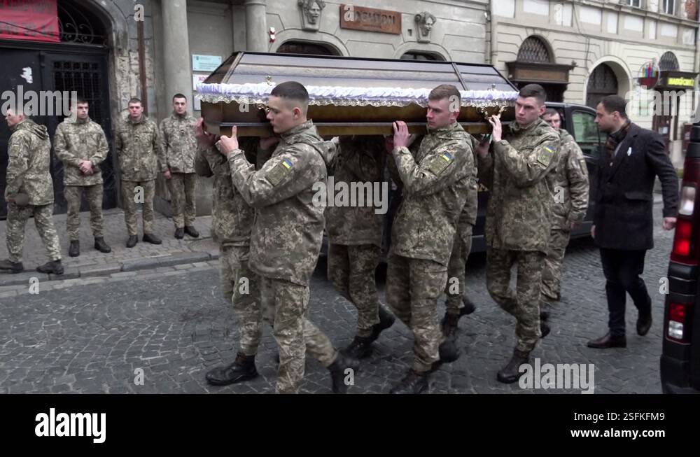 Ukrainian soldiers carry a fallen comrade’s coffin on their shoulders ...