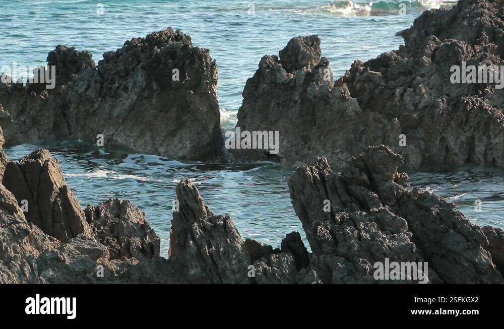 Sharp rocks in the sea. Rocky sea shore Stock Video Footage - Alamy
