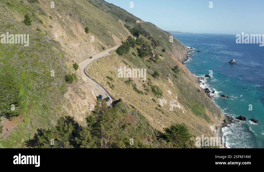 Cars drive scenic coastal Highway 1 in California overlooking ocean on ...