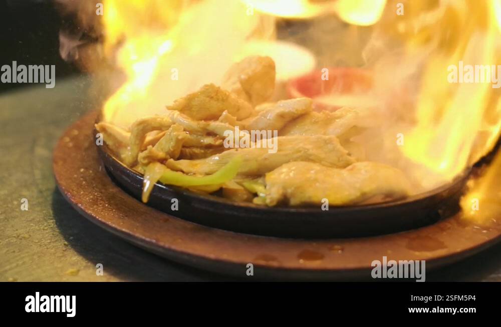 Cooking flambe style chicken fajita..close up,slow motion.4K Stock ...