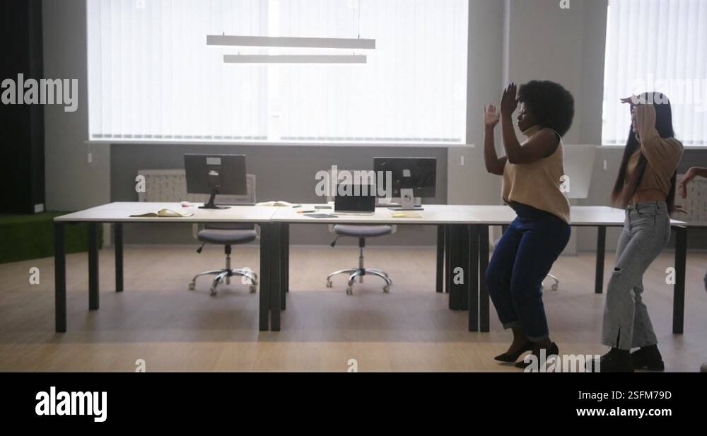 Multinational employees go in single file dancing in office Stock Video ...