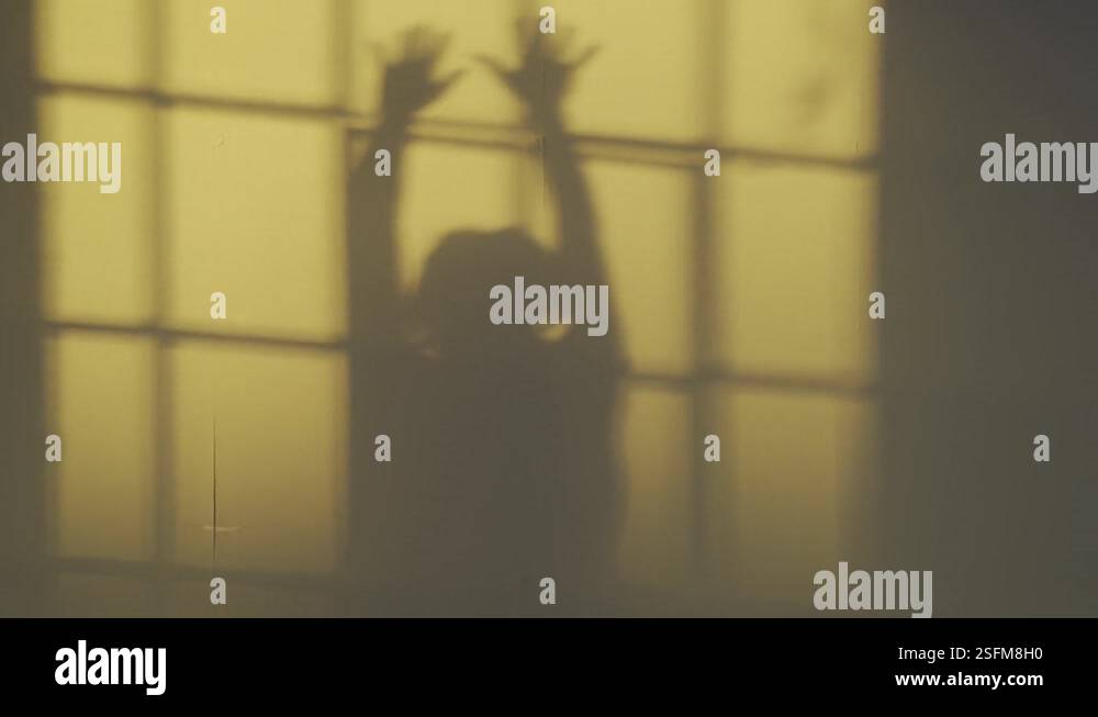 4K Shadow of women silhouette stretching out arms on projected over ...