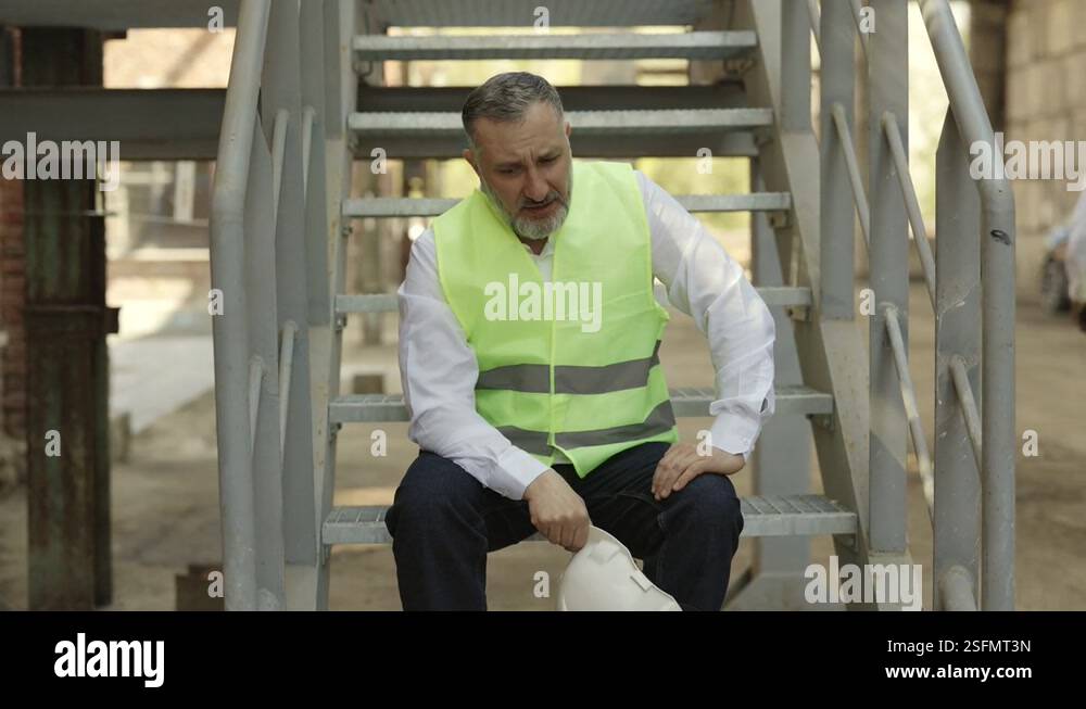 Upset handsome engineer sitting on building stairs Stock Video Footage ...