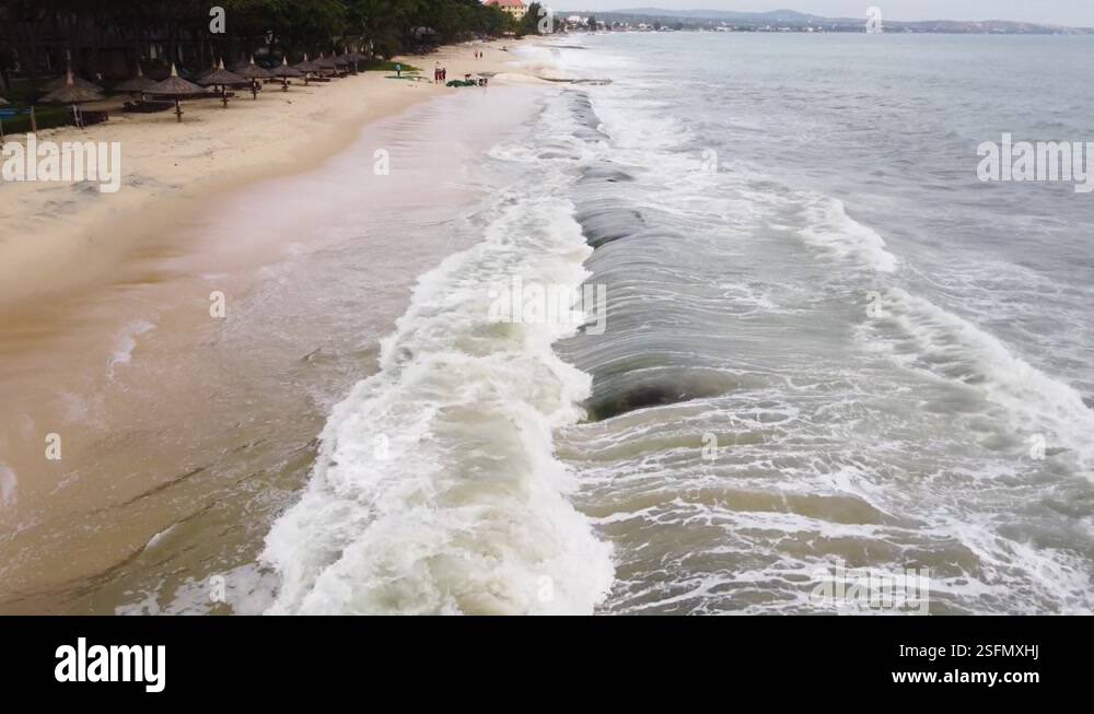Geotubes used on beach to prevent beach erosion along coastline; drone ...