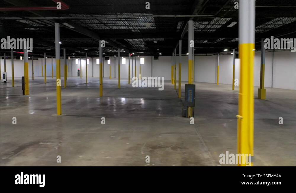 Slider Shot View of the Inside of a Large, Dark Commercial Warehouse ...
