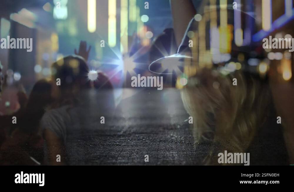 Animation of road at night over diverse people dancing during concert ...