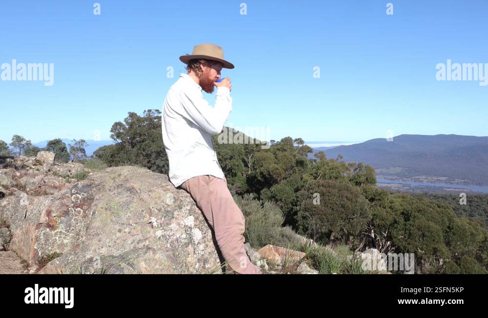 A bushman in an akubra hat drinking coffee on top of a moutain Stock ...