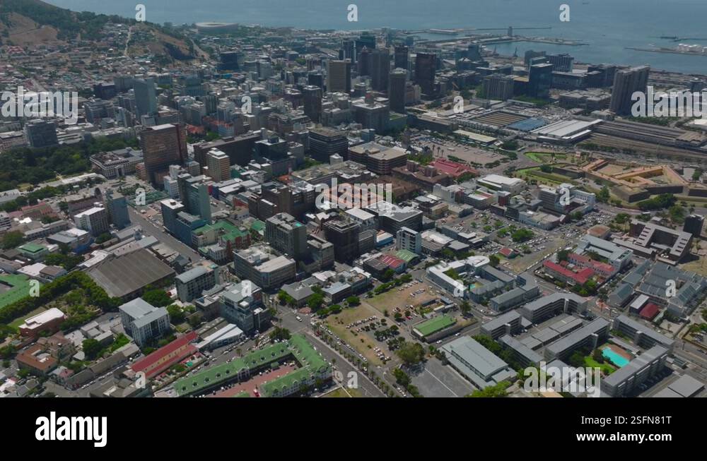 High angle view of buildings in city. Tilt up reveal of downtown and ...