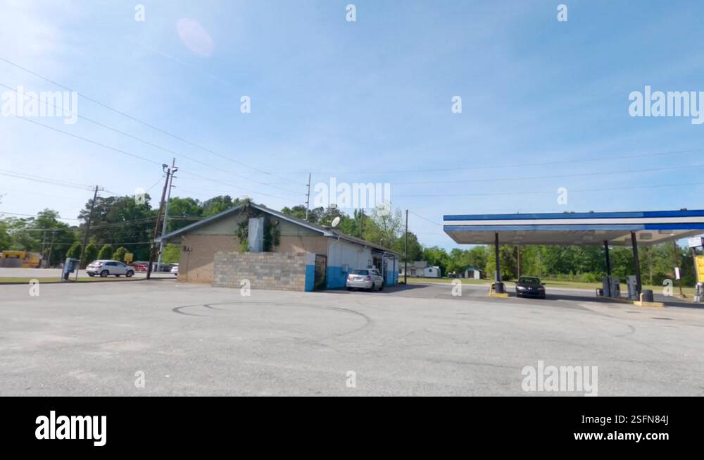 Pan around urban gas station and abandoned vintage retail strip mall of ...