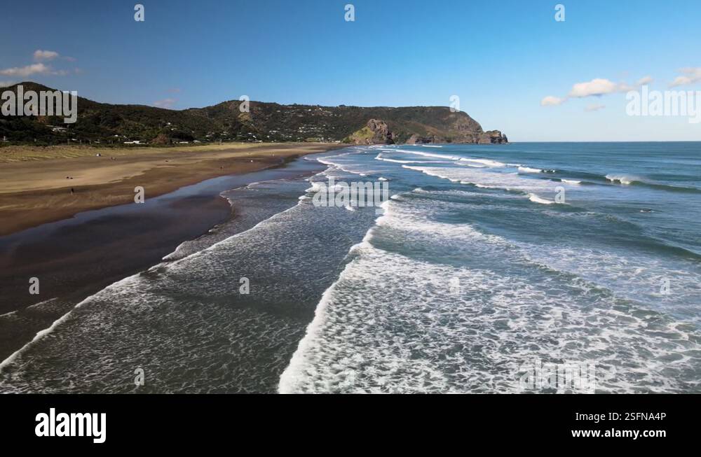 Flying low across shallow surf and black sand beach Stock Video Footage ...