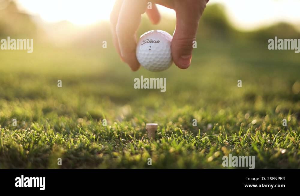 Titleist Golf Ball on Tee at Golf Course Driving Range with Sunset Sun ...