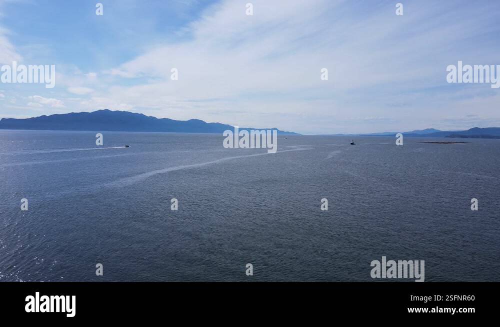 Boats sailing out on the deep, open ocean near Smuggler Cove in British ...