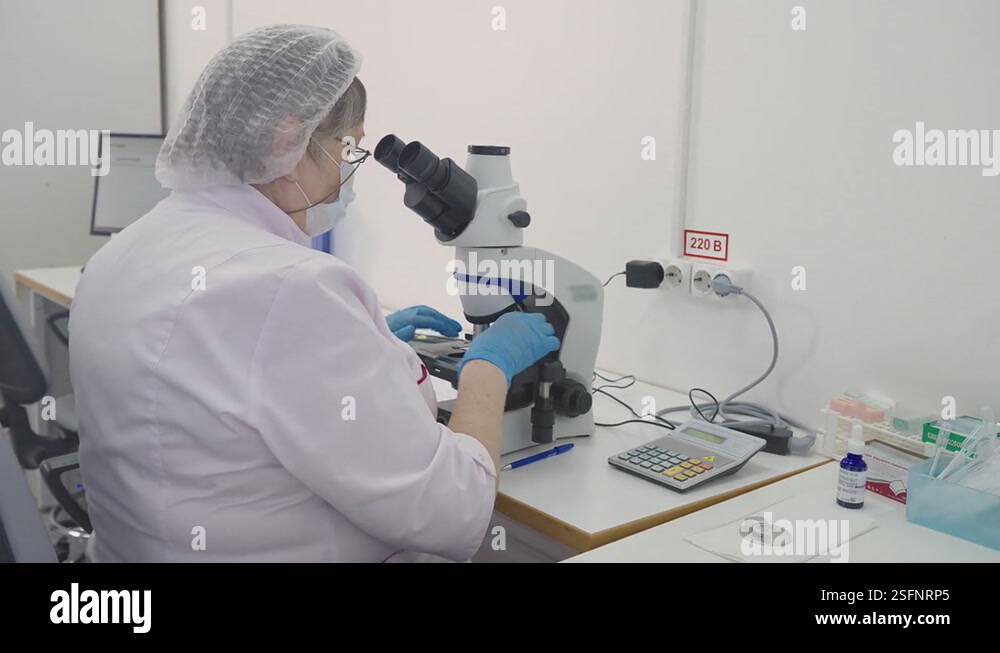 Medical Worker Conducts Microscopic Blood Test To Diagnose Disease In ...
