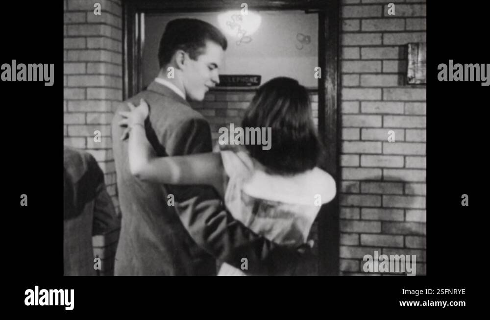 1950s: Boy and girl dance towards exit, walk through exit. Teenage ...