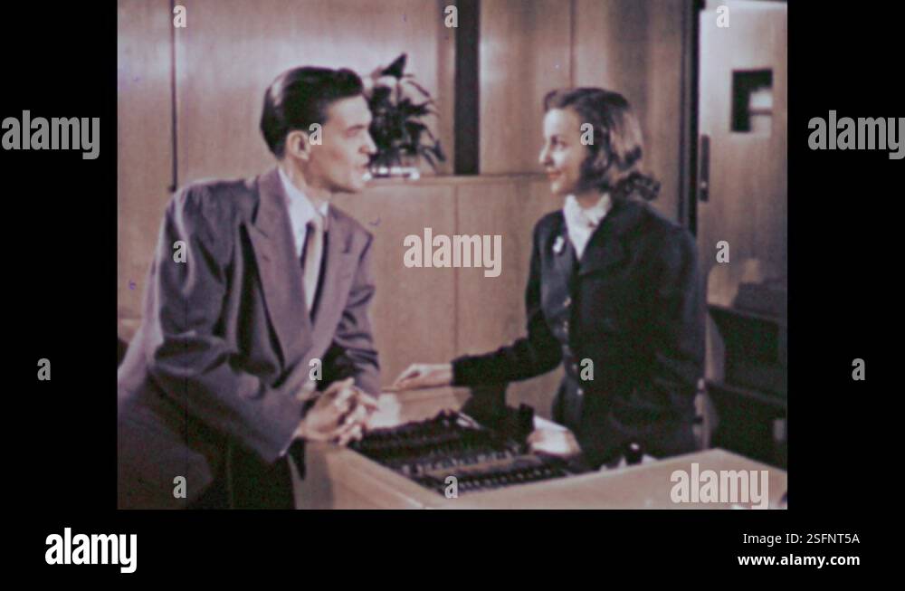 1950s: People sit behind tables. Man speaks. Woman and man walk down ...