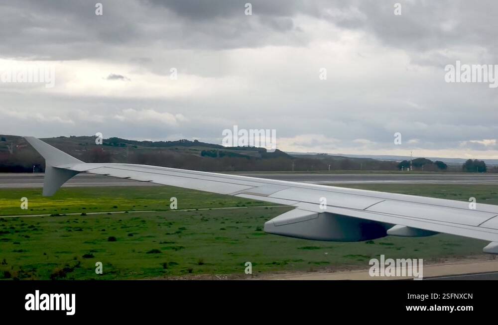 A commercial plane lands at Spanish airport (could be anywhere). Green ...