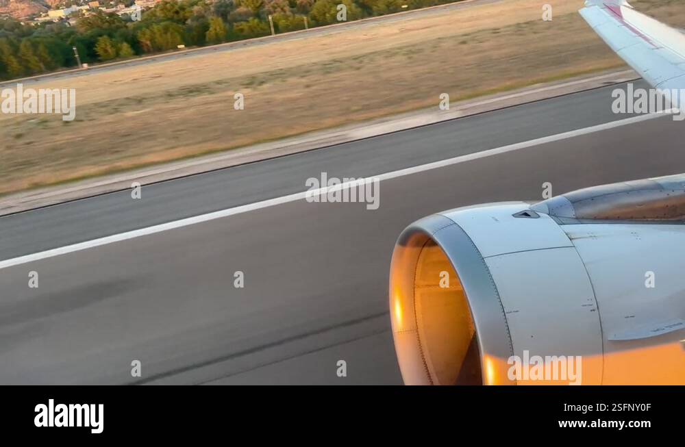 Right engine and wing of a jet plane during the take off roll and ...