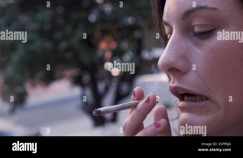 Women smoking outside. taking a puff of white smoke in the air Stock ...