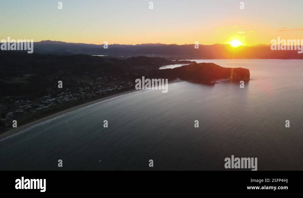 Watching the golden hour glow fade out from the sky over ocean water in ...