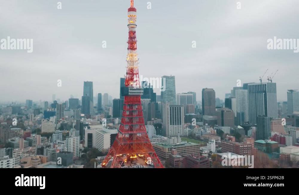 Drone aerial above Tokyo City panning around the iconic red Tokyo Tower ...