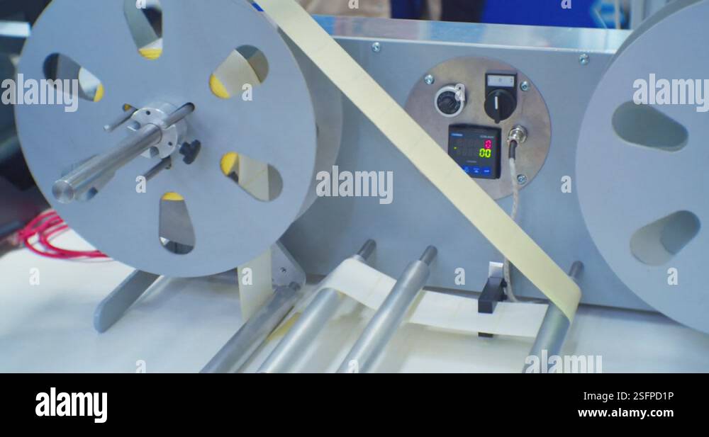 tape with labels is wound on a reel of a labeling machine Stock Video ...