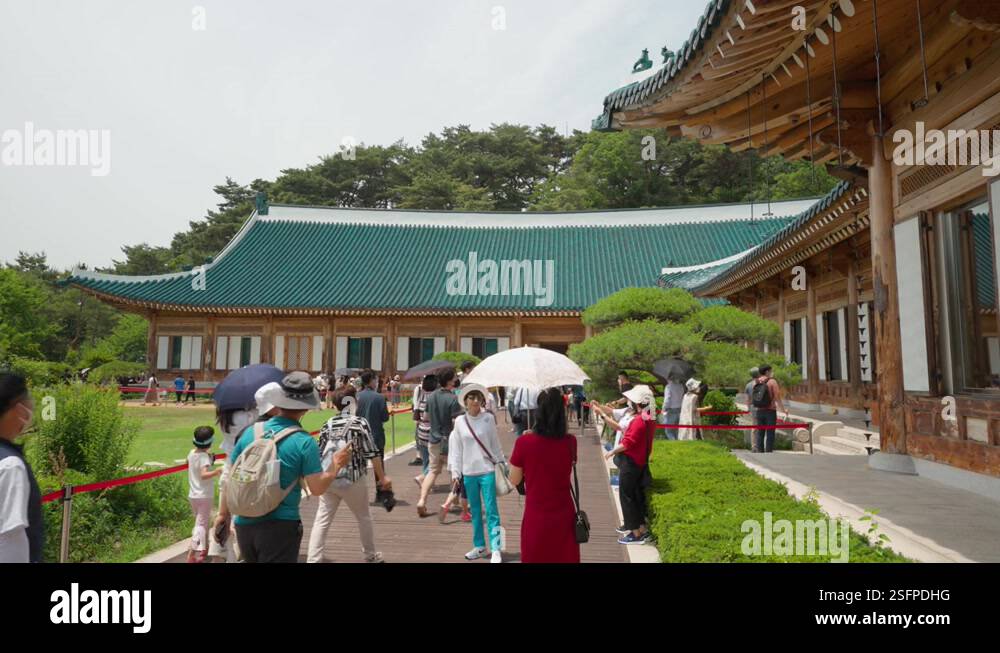 People walk by and take pictures next to Presidential Residence in ...
