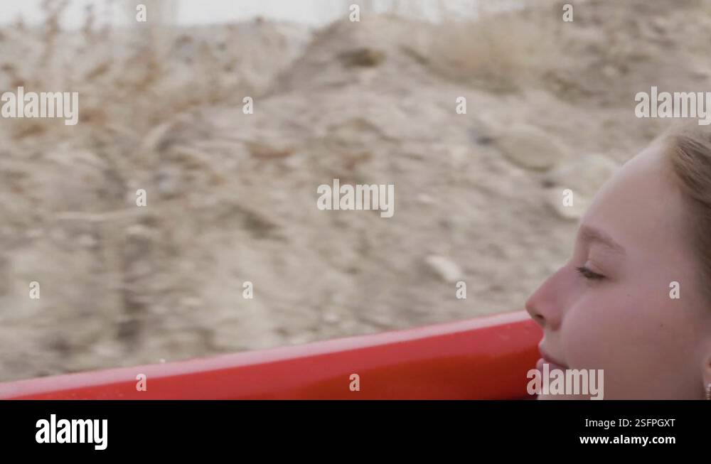 Close-up face of teenage girl with hair fluttering in wind in moving ...