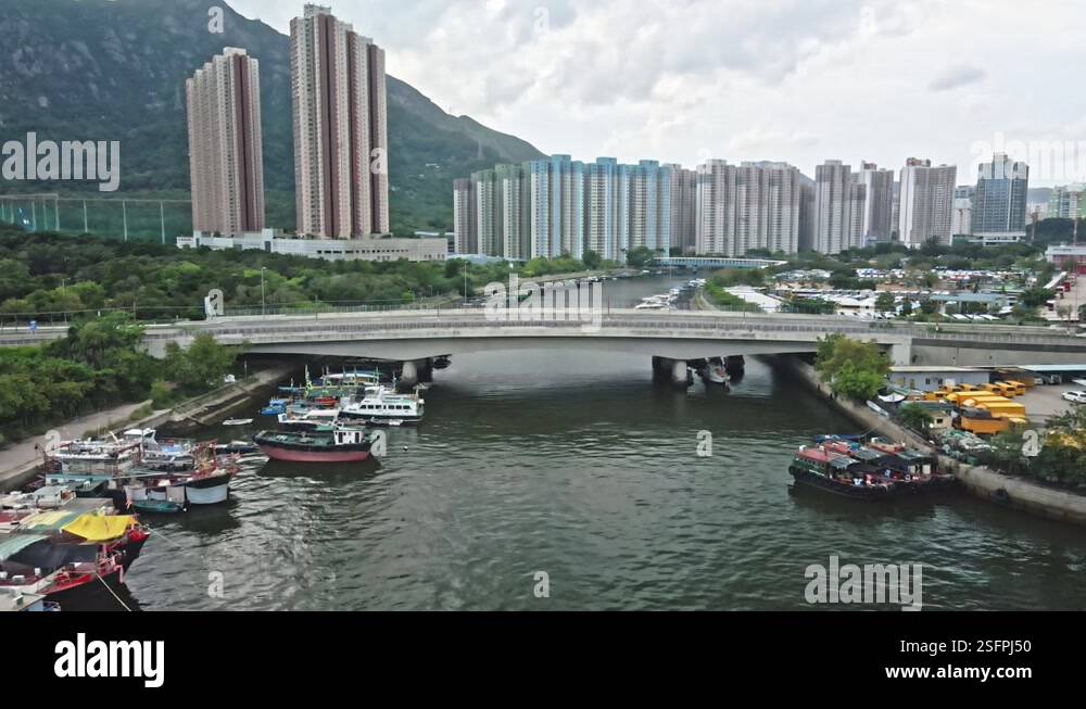 Hong Kong MTR Light Rail passing over bridge spanning Tuen Mun river ...
