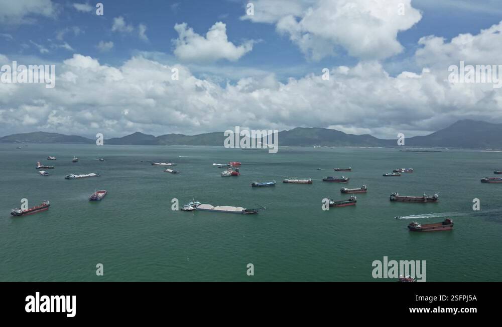 A pan shot of a sea in Tuen Mun where cargo and sand boat idling in the ...