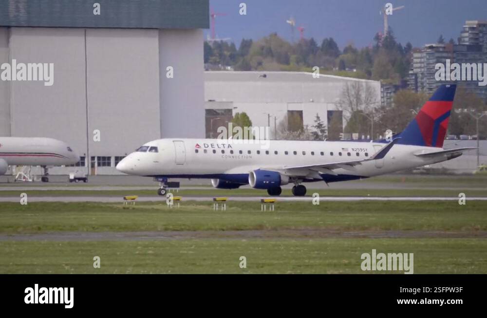 A Delta Airlines Embraer E175 Plane Taking Off From Vancouver Airport ...