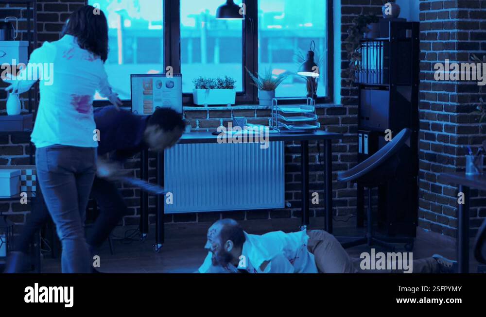 Afraid businessman hiding under table from hungry brain-eating monsters ...