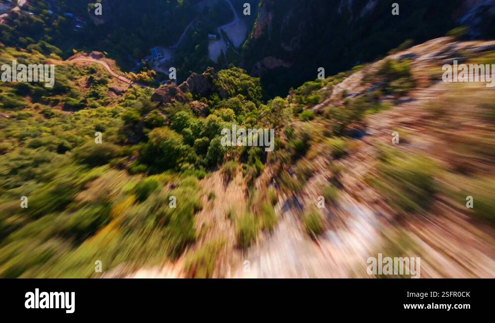 FPV Dynamic drone shot. Aerial flight downhill the green mountains ...
