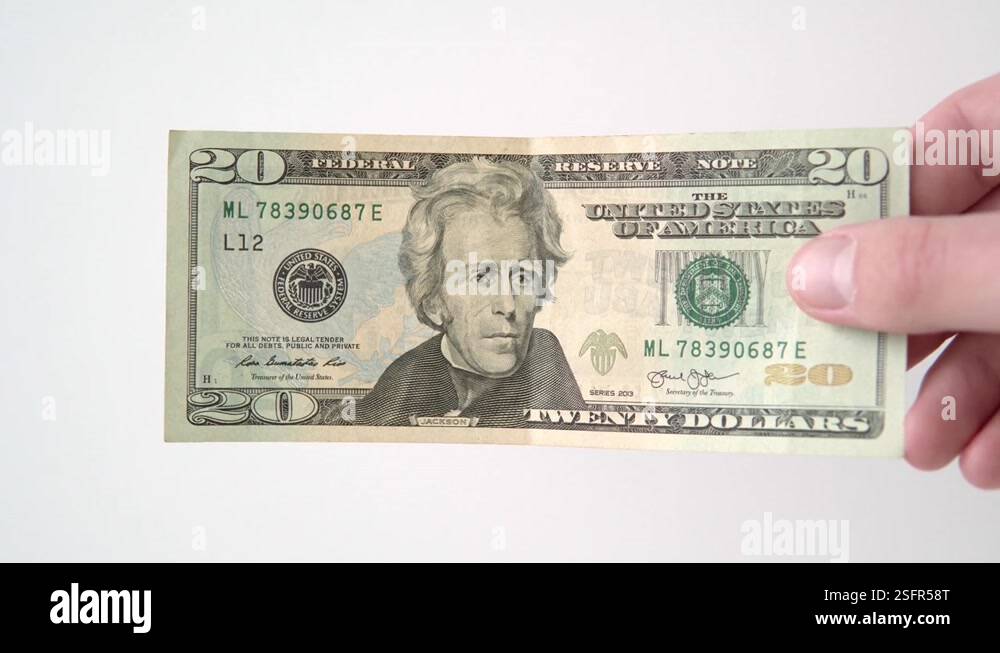 A hand shows a 20 dollar bill, a man holds a banknote on a white ...
