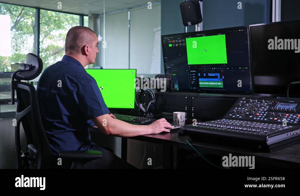 Video editor using software to edit on chroma key green screen, mock up ...