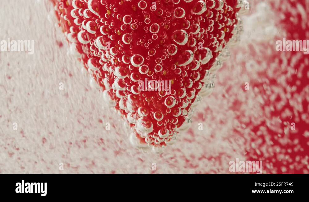 Strawberry in carbonated water. Cooking sweet cocktail, fizzy summer ...